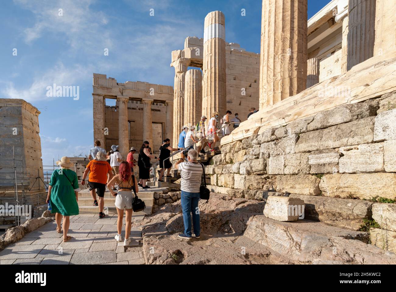 Tourists are visiting the Archaeological site of Acropolis while ...