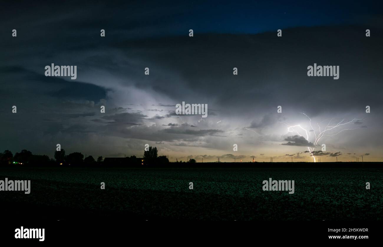 Large storm cloud, spawning upward lightning Stock Photo - Alamy