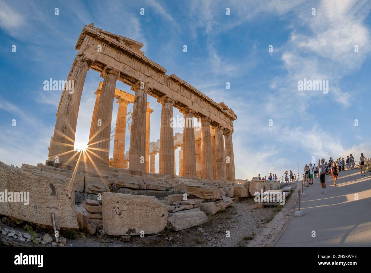 Parthenon Temple at the archaeological site of Acropolis. Sun shines through the ancient columns ...