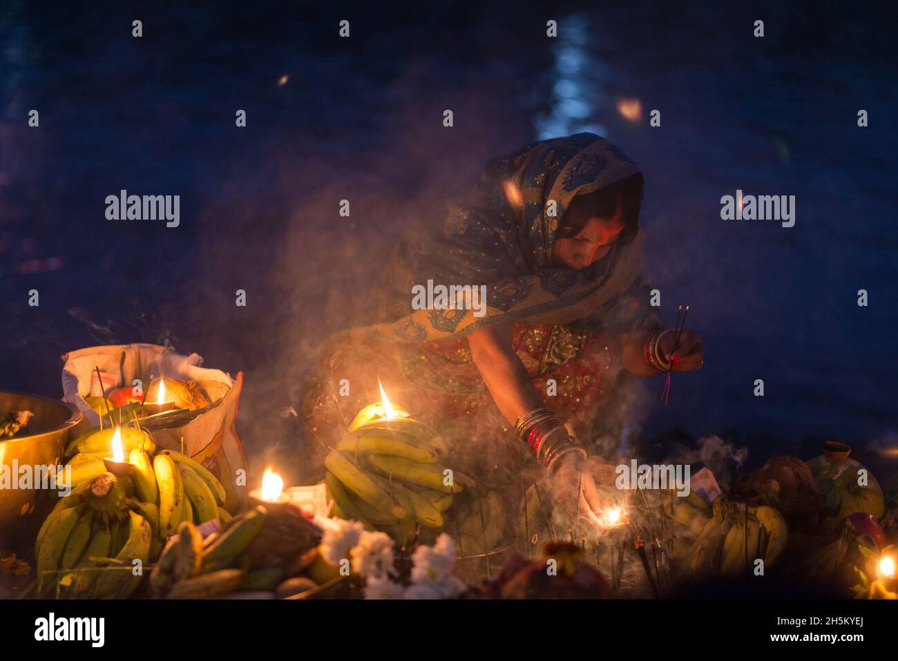 A devotee performs rituals during the celebration of Chhath puja at ...