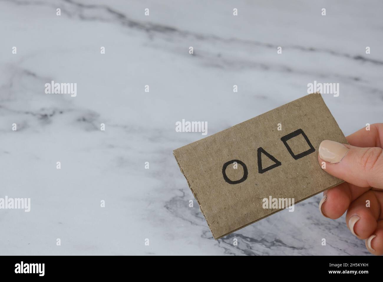 Kiev Ukraine - October 2021 Hand holding a squid game invitation card ...