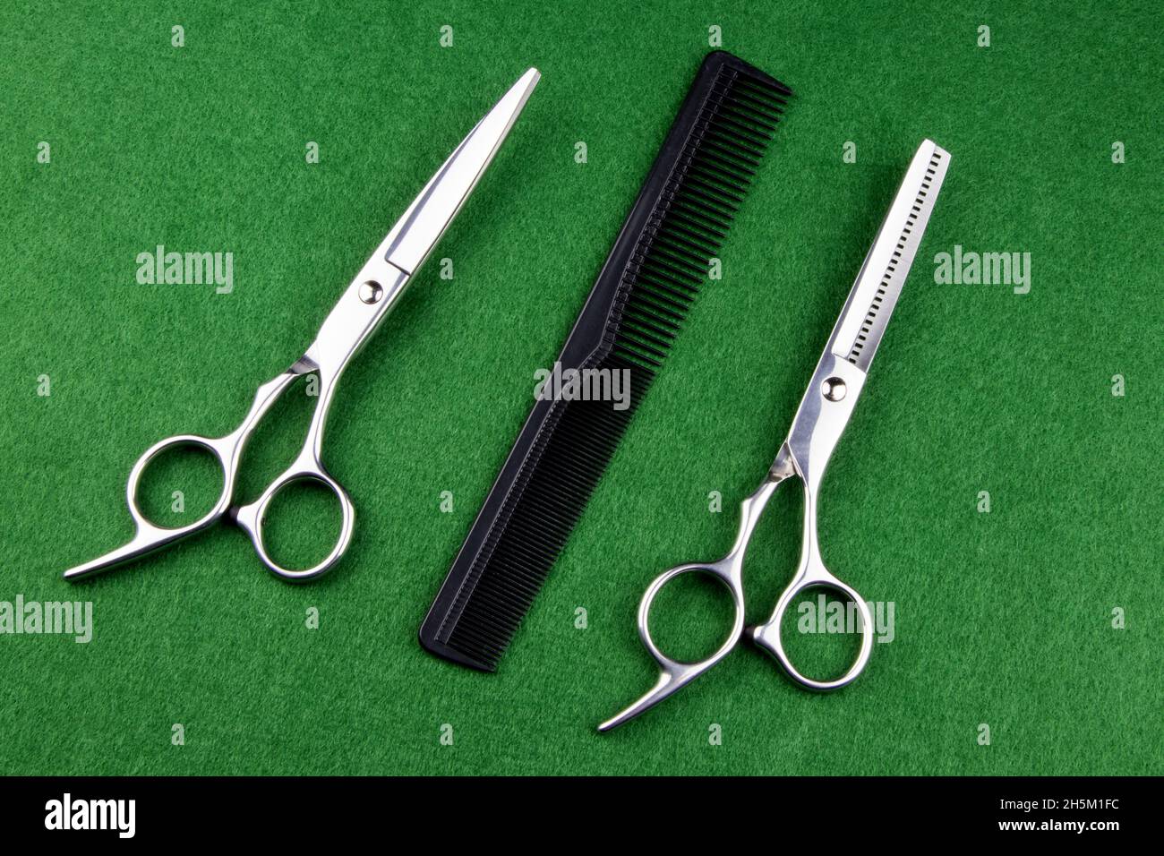 Scissors cutting black cloth hi-res stock photography and images - Alamy