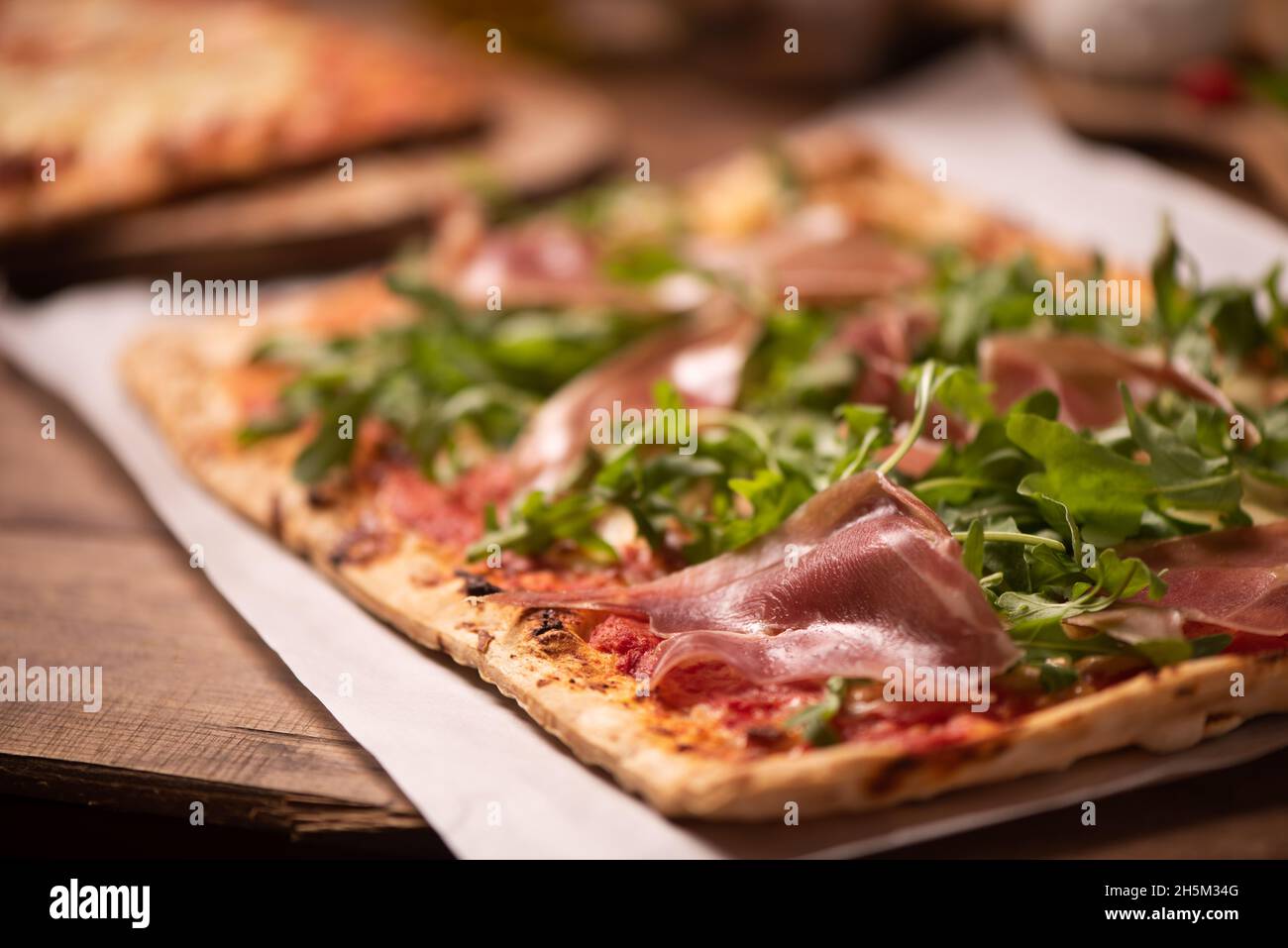 Homemade rectangular pizza on a rustic table close up Stock Photo - Alamy