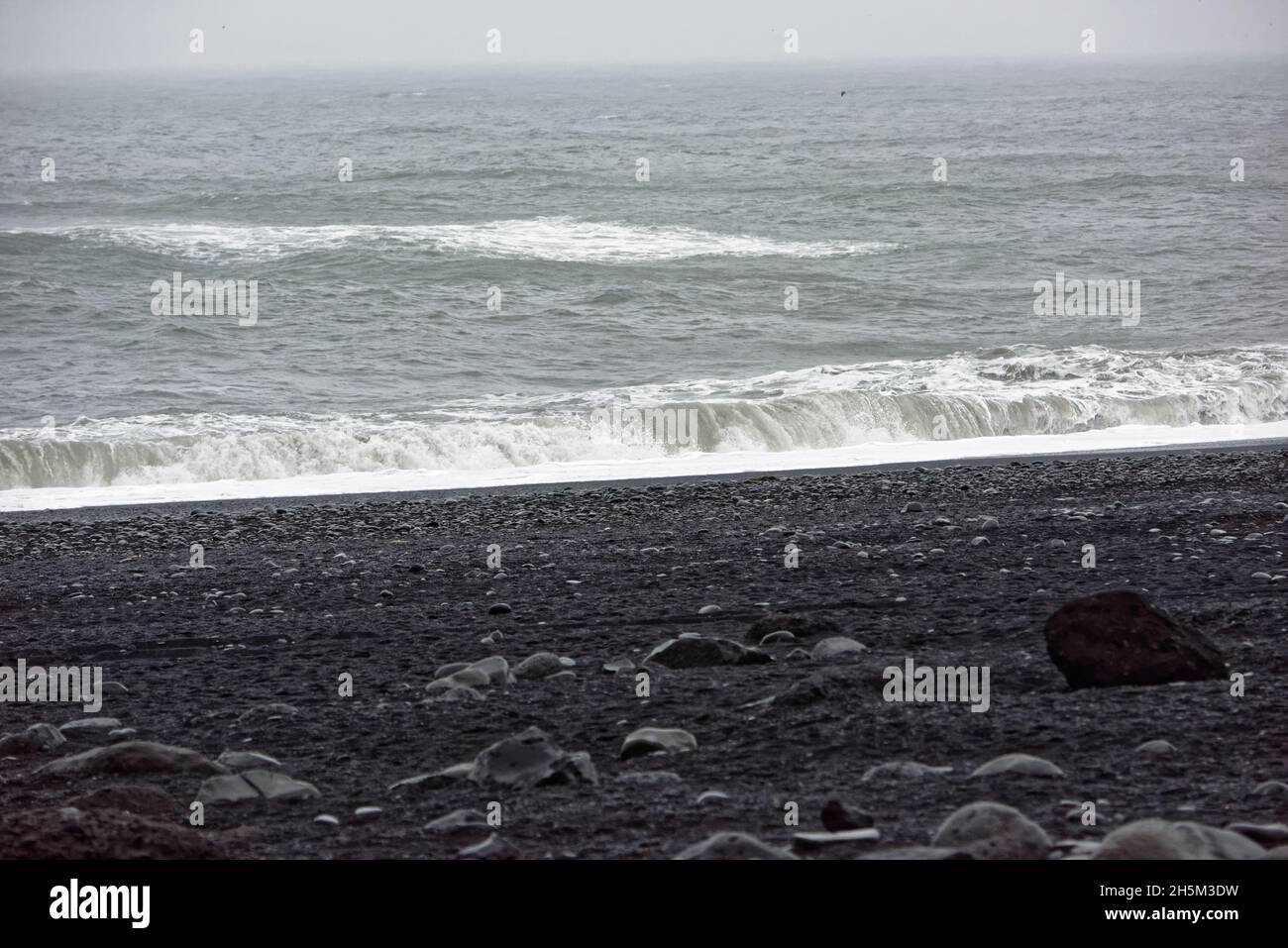The Reynisdrangar basalt sea stacks and the Reynisfjara black sand ...