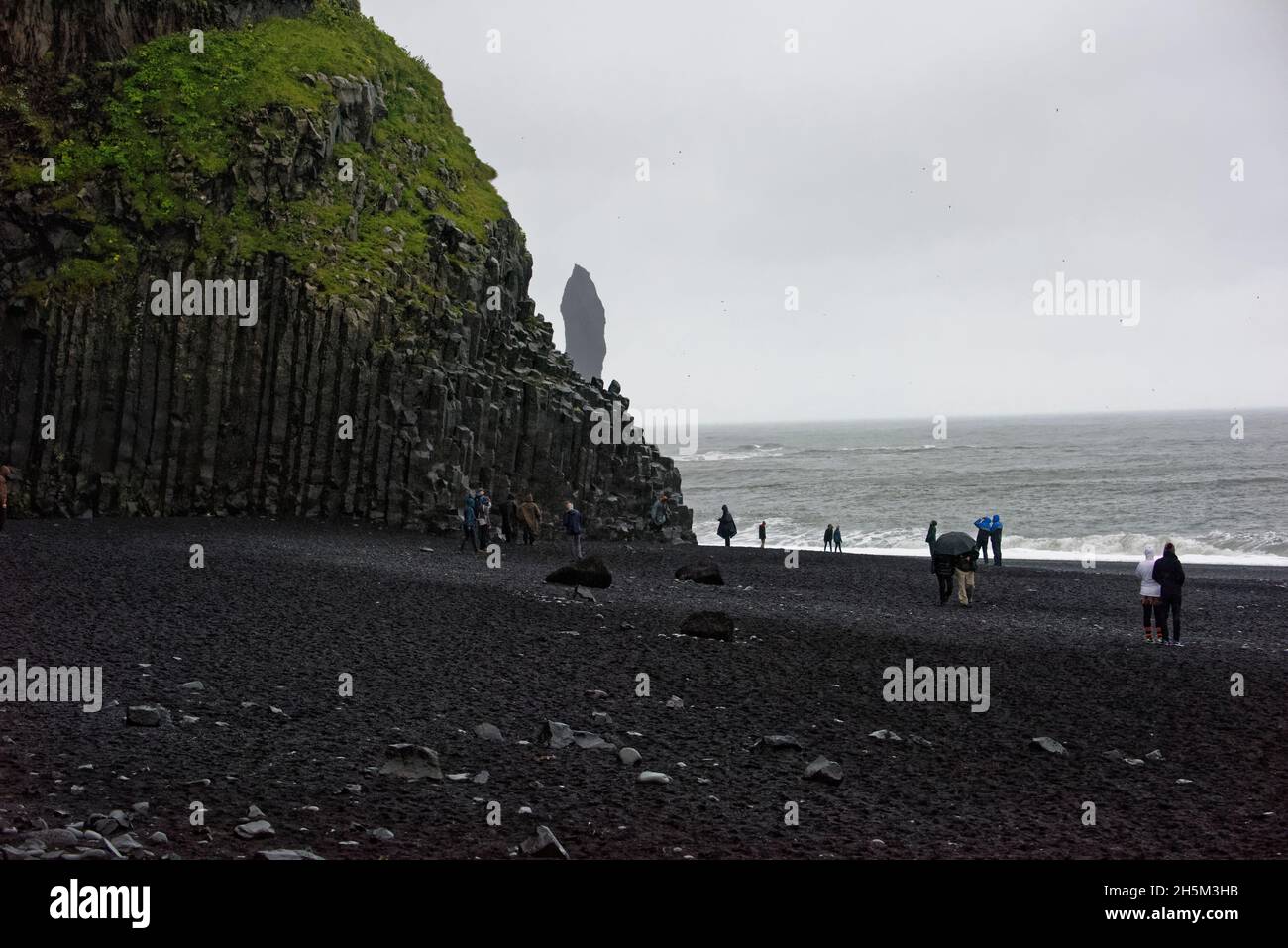 The Reynisdrangar basalt sea stacks and the Reynisfjara black sand ...