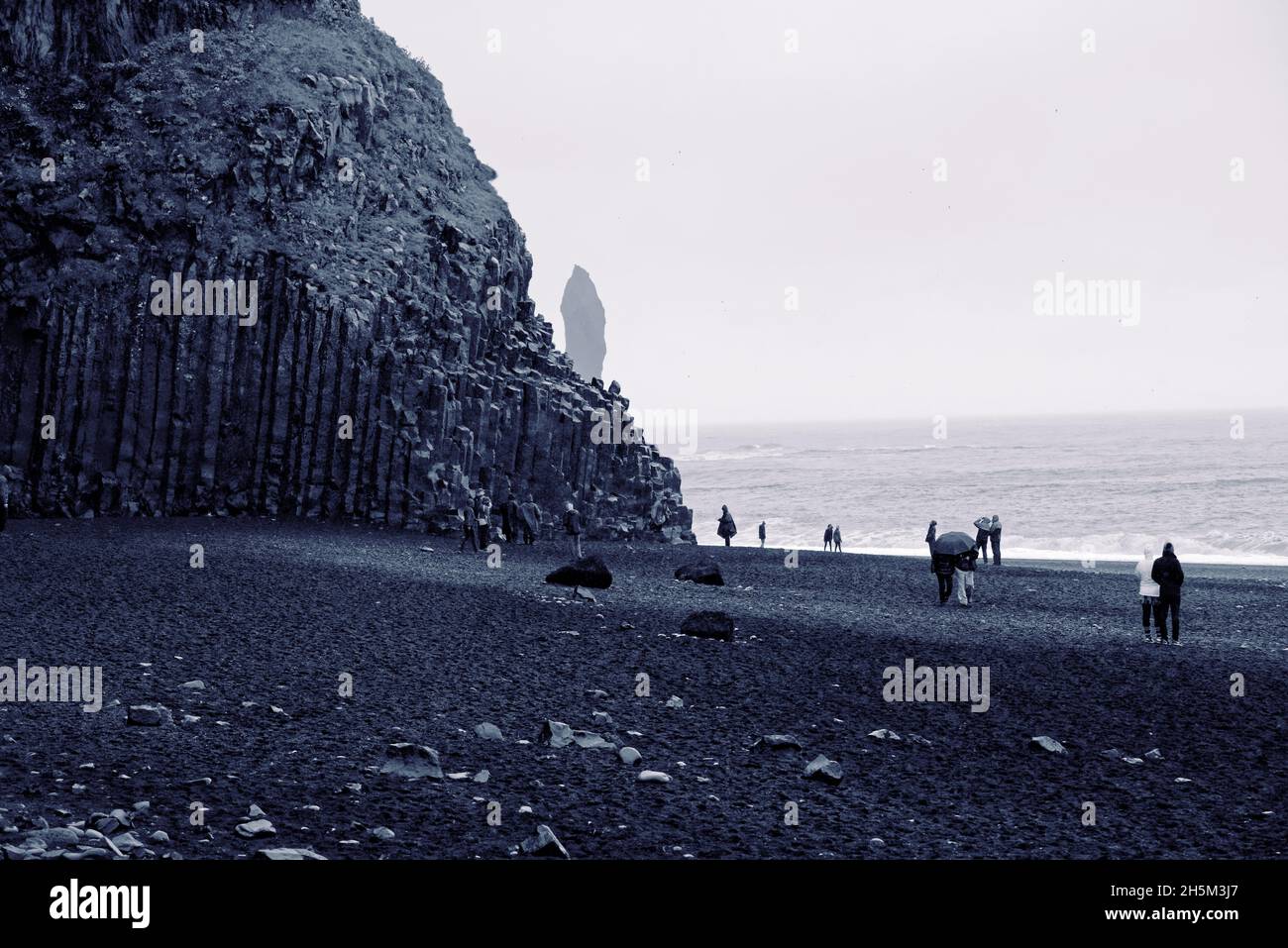 The Reynisdrangar basalt sea stacks and the Reynisfjara black sand ...