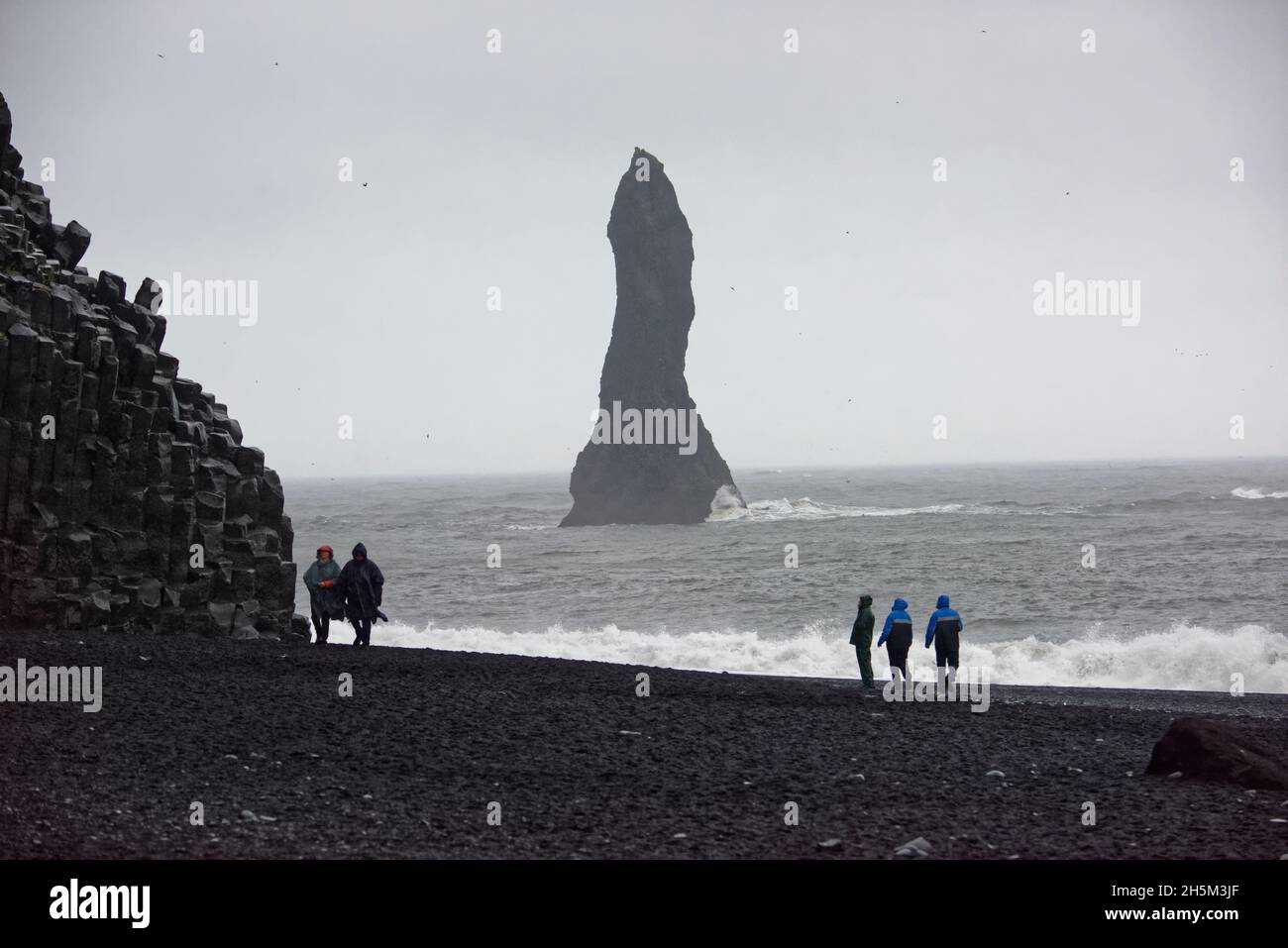 The Reynisdrangar basalt sea stacks and the Reynisfjara black sand ...