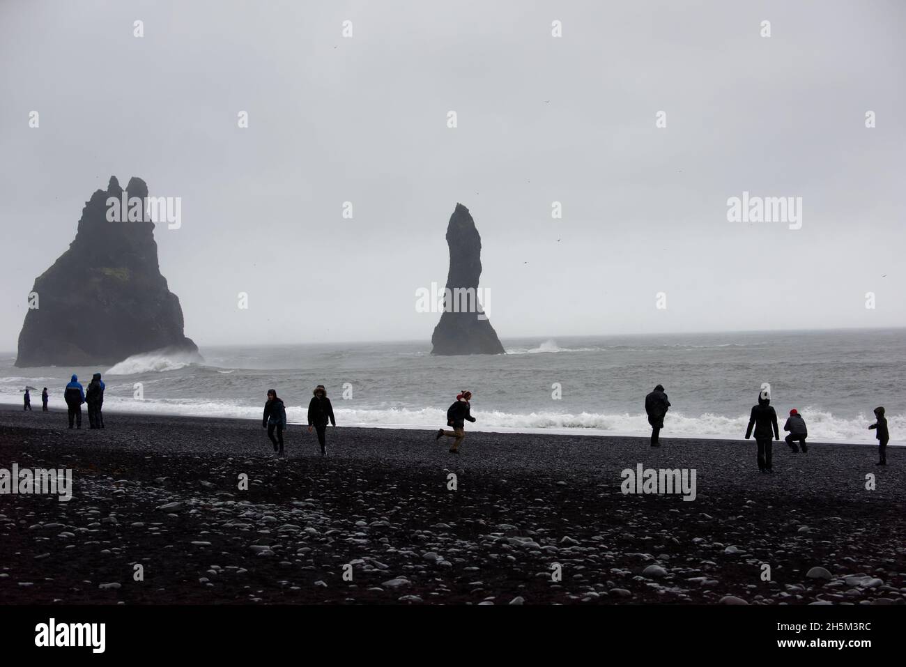 The Reynisdrangar basalt sea stacks and the Reynisfjara black sand ...
