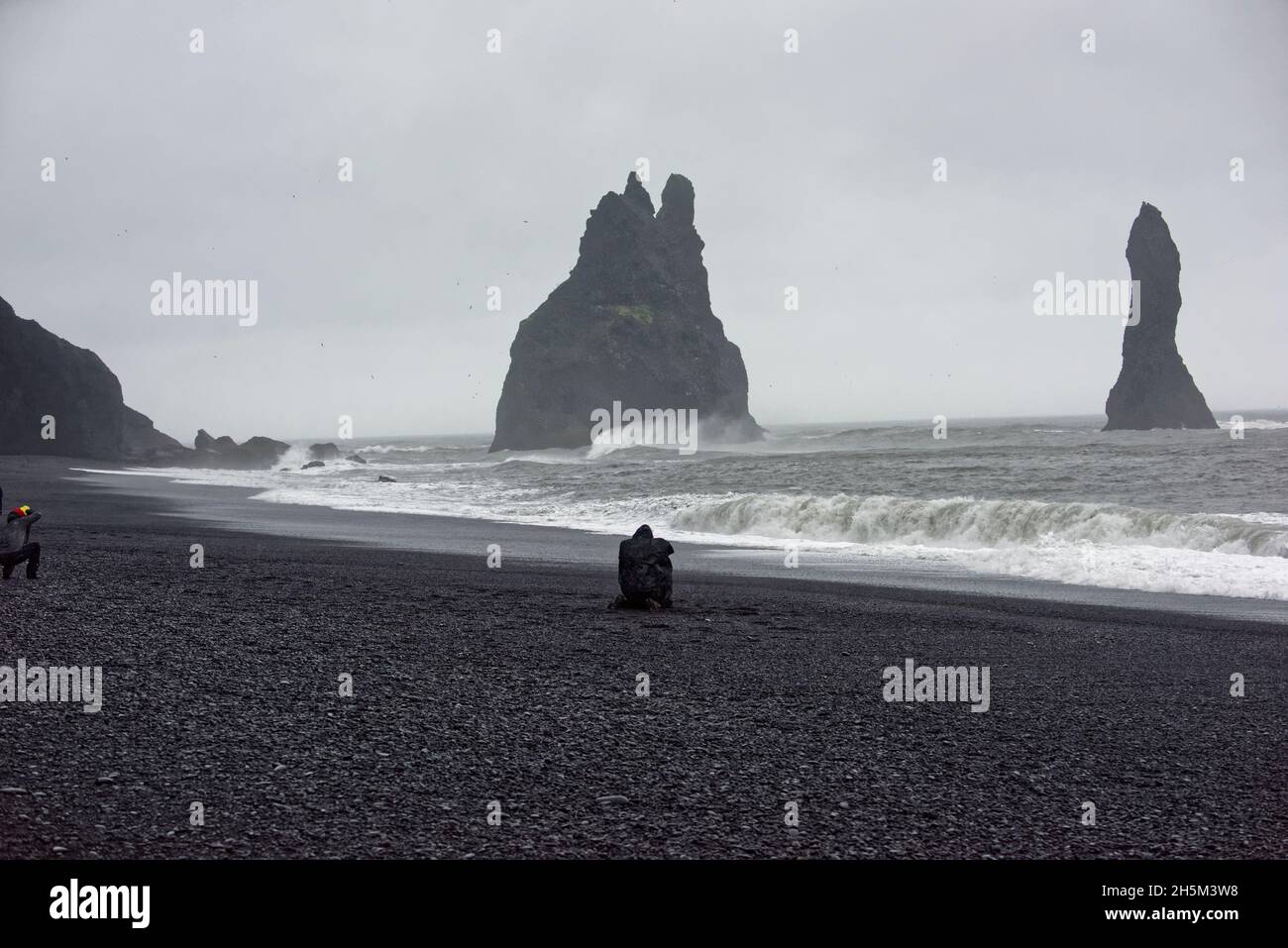 The Reynisdrangar basalt sea stacks and the Reynisfjara black sand ...
