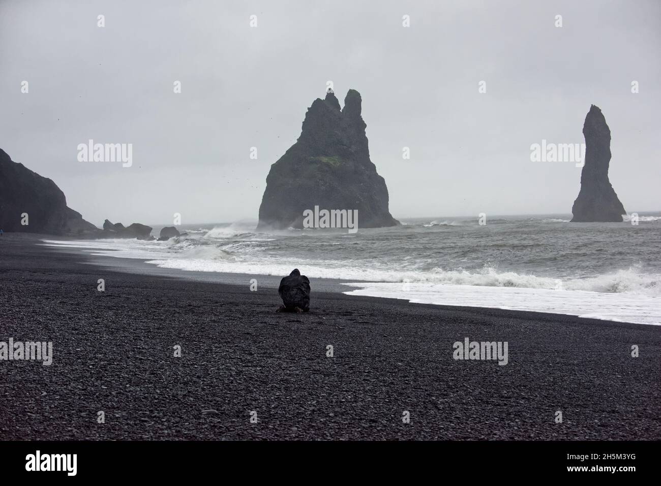The Reynisdrangar basalt sea stacks and the Reynisfjara black sand ...