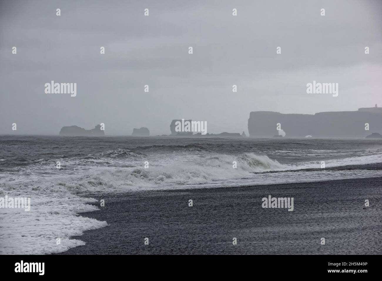 The Reynisdrangar basalt sea stacks and the Reynisfjara black sand ...