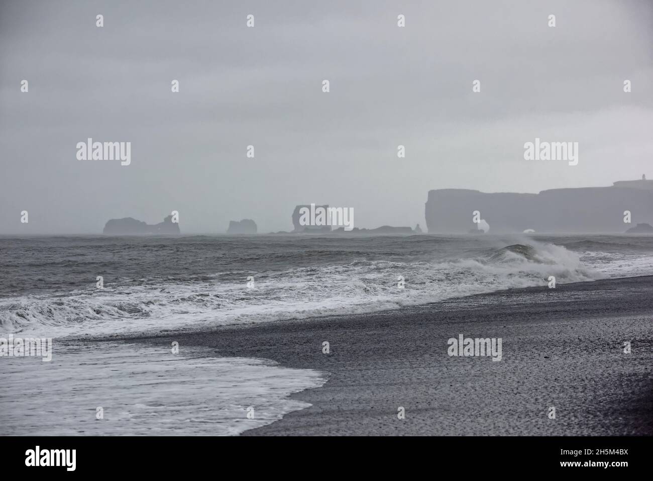 The Reynisdrangar basalt sea stacks and the Reynisfjara black sand ...