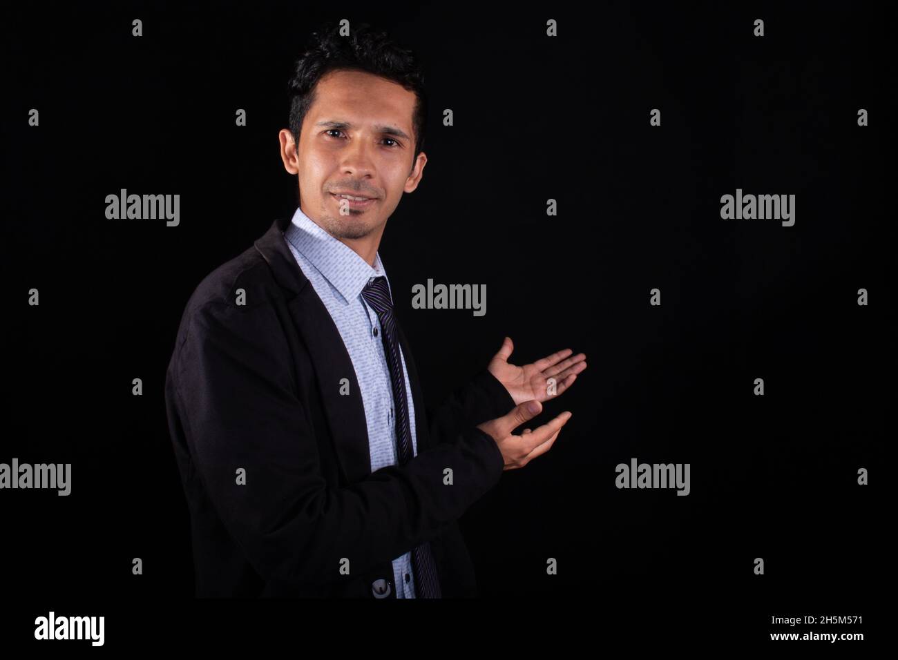 Businessman showing, explaining or presenting something with his two ...