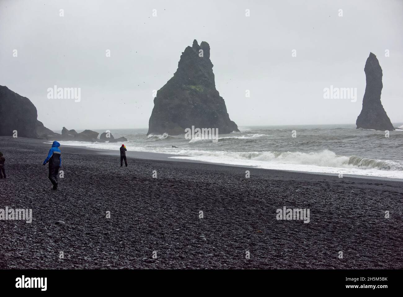 The Reynisdrangar basalt sea stacks and the Reynisfjara black sand ...