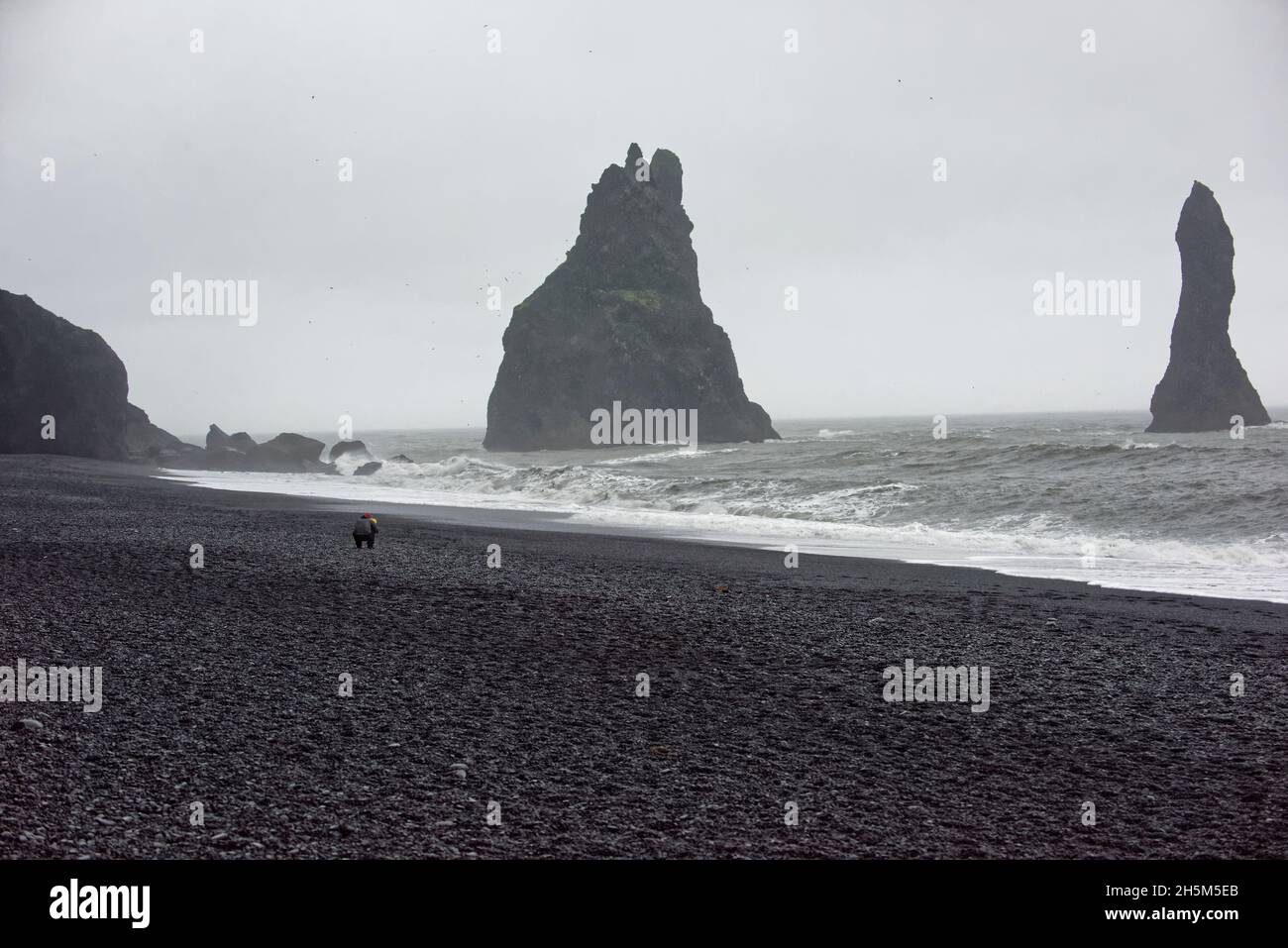 The Reynisdrangar basalt sea stacks and the Reynisfjara black sand ...