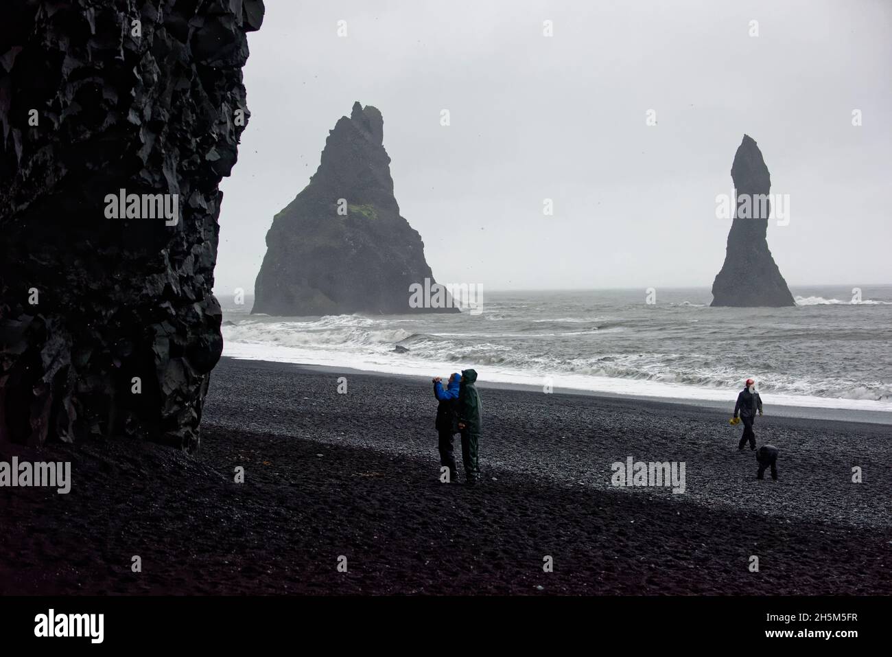 The Reynisdrangar basalt sea stacks and the Reynisfjara black sand ...