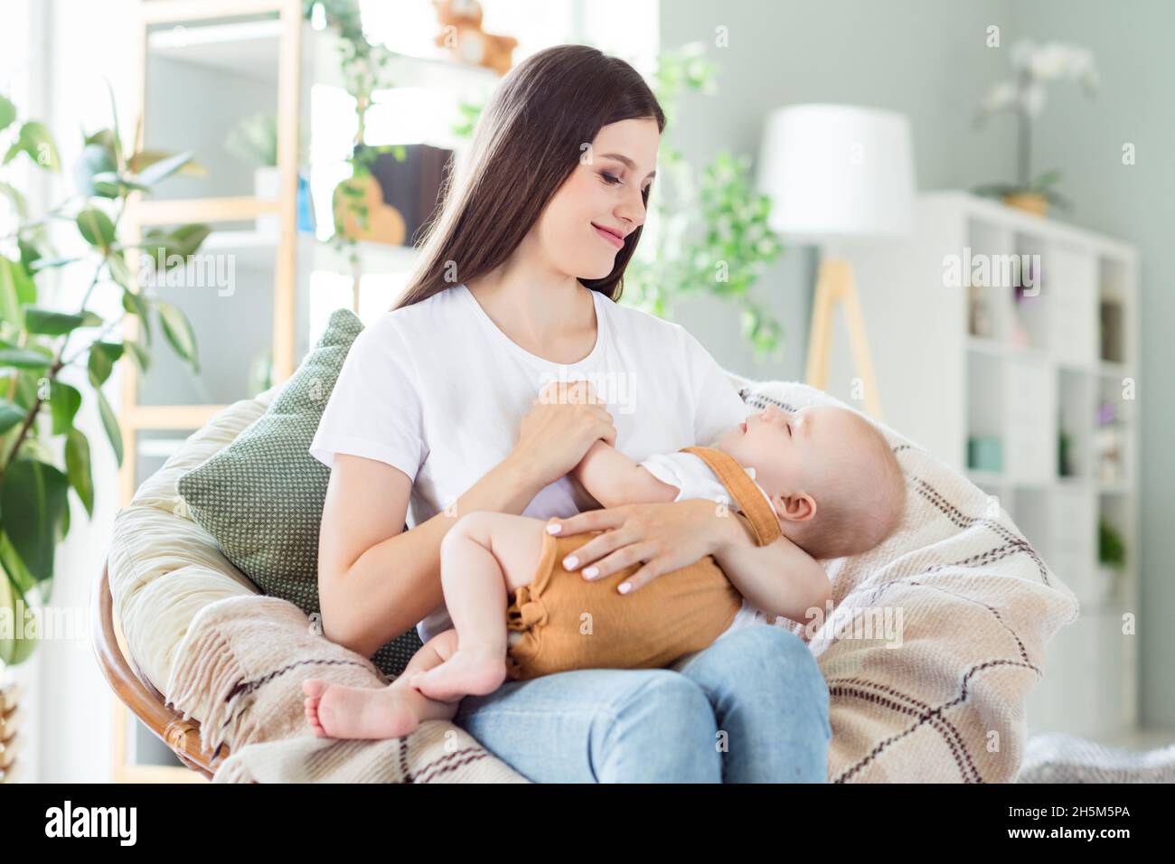 Photo of trustful dreamy mom charming caring lady hold little boy sit ...