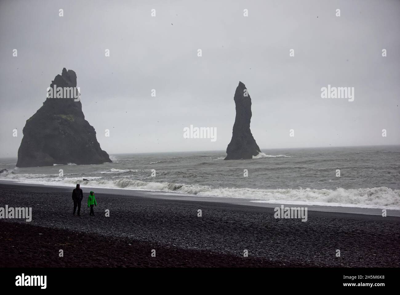 The Reynisdrangar basalt sea stacks and the Reynisfjara black sand ...