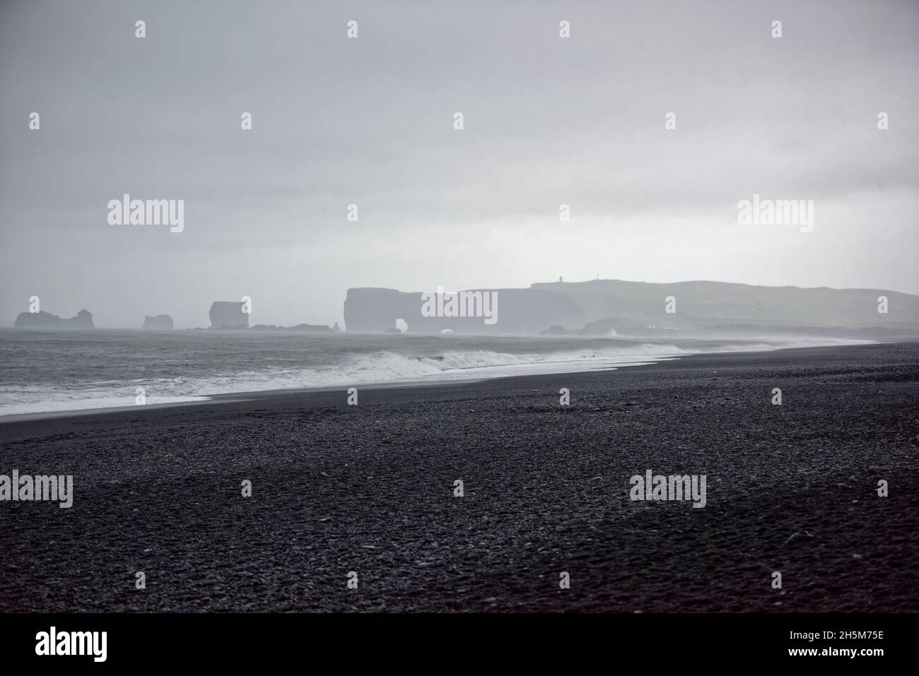 The Reynisdrangar basalt sea stacks and the Reynisfjara black sand ...