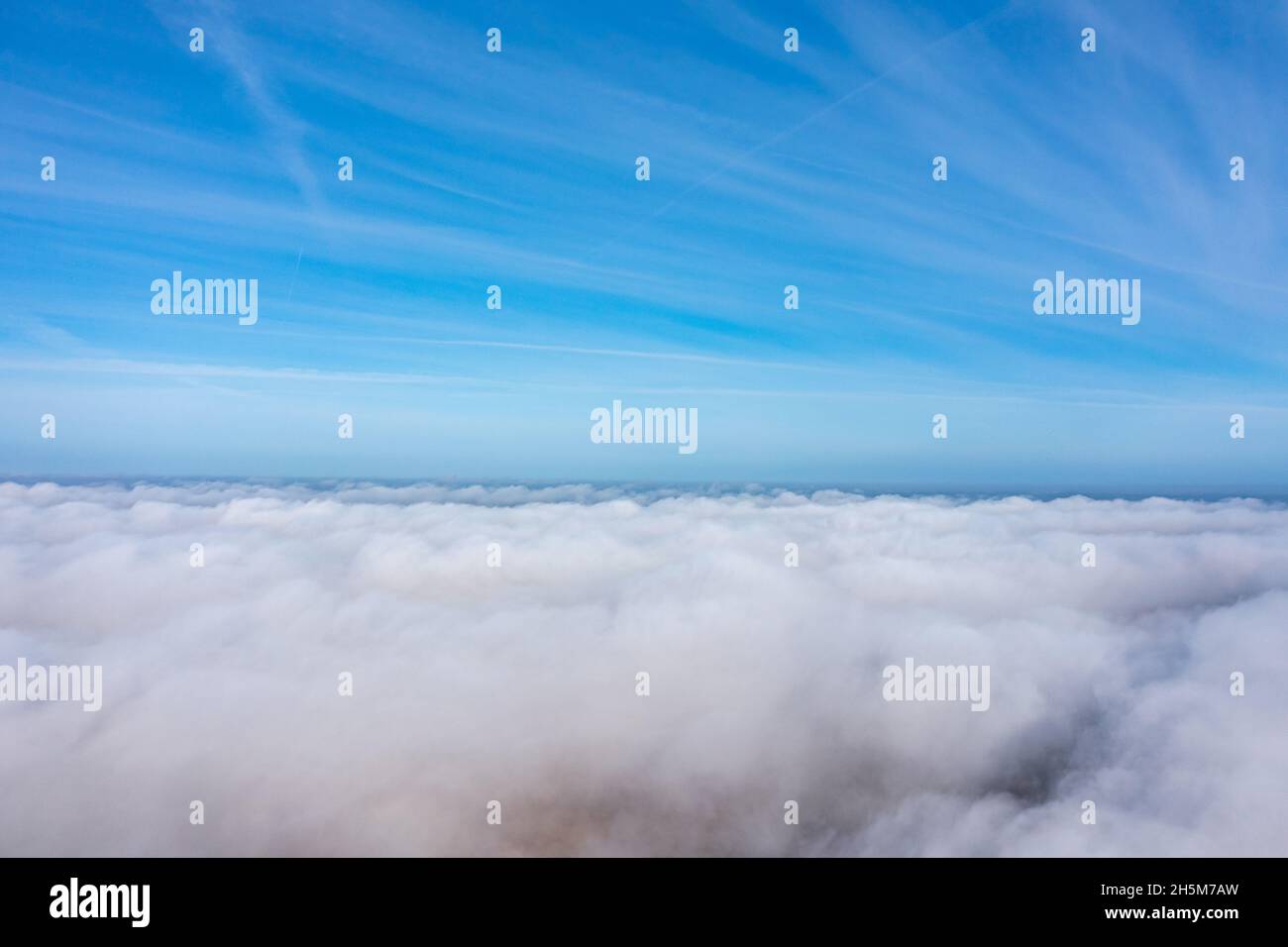 Landscape above the clouds, aerial view of blue sky and clouds below ...