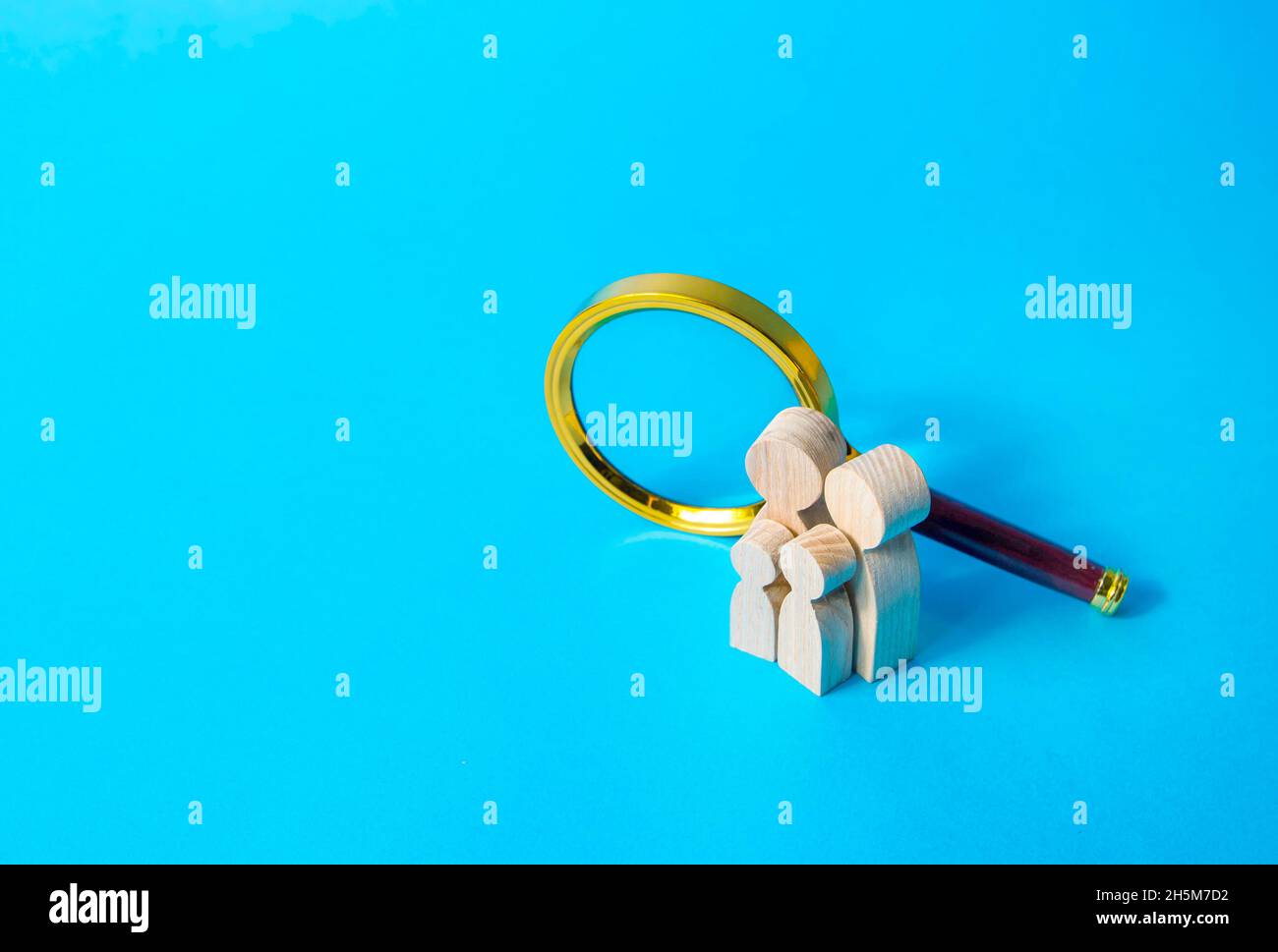 Family figurines and magnifying glass. Finding a partner to create a ...