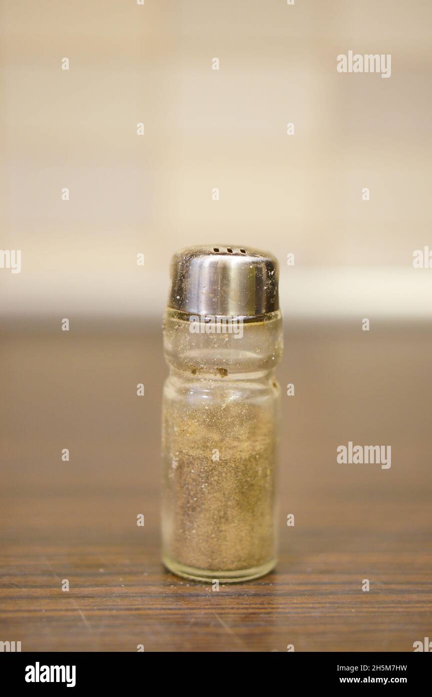 Black pepper shaker on the table Stock Photo - Alamy