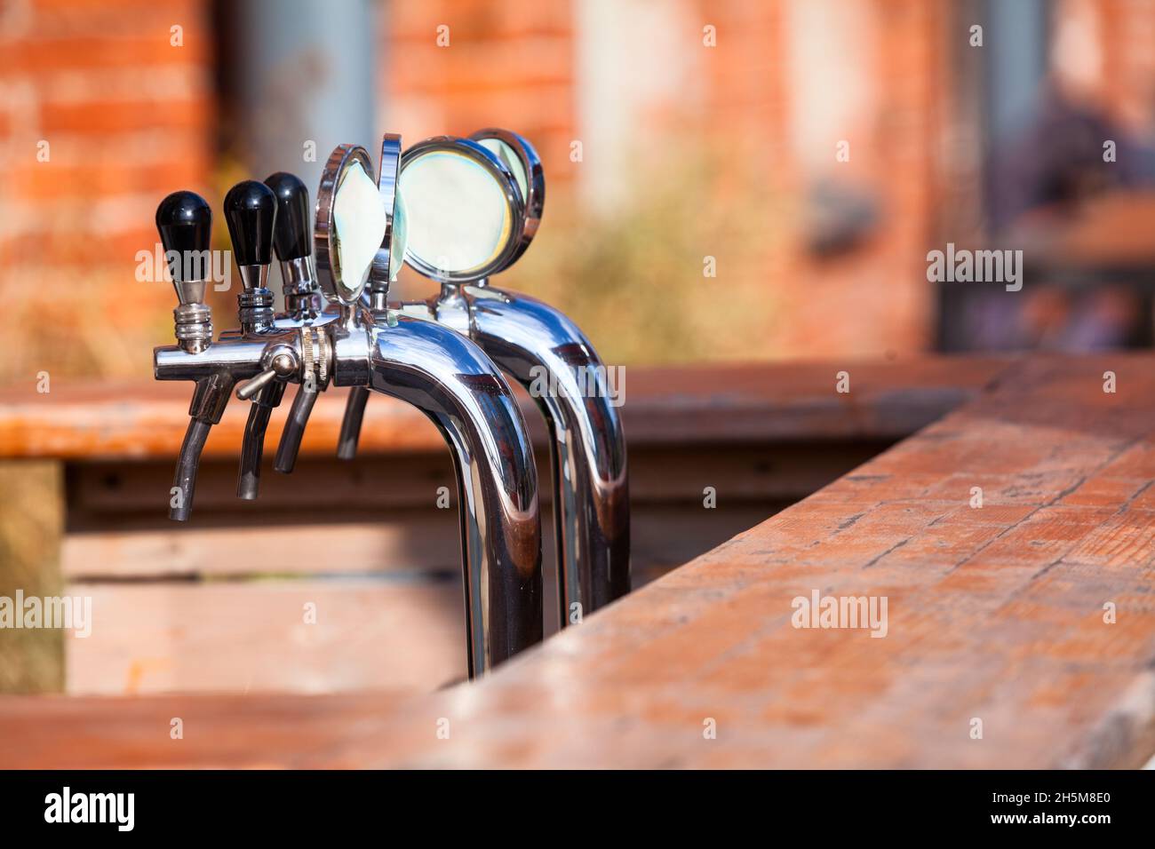 Steel chrome beer taps are on bar counter, outdoors Stock Photo - Alamy