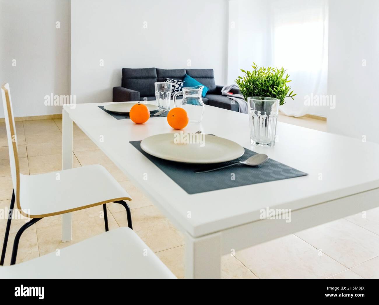 Simple white table in a very simple and bright minimalist living room ...