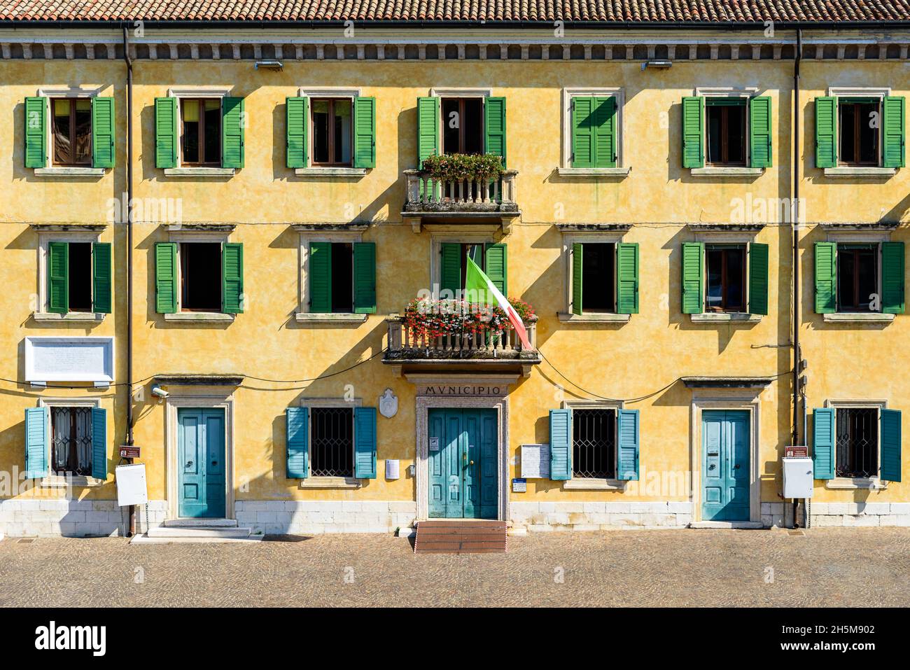 Facade of a public building of the Italian municipality facing the sun ...