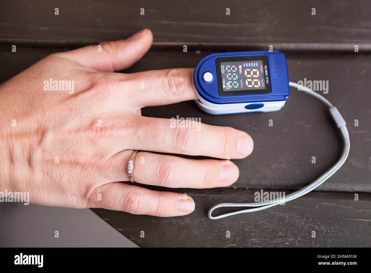 Person using oximeter for monitoring peripheral oxygen saturation ...