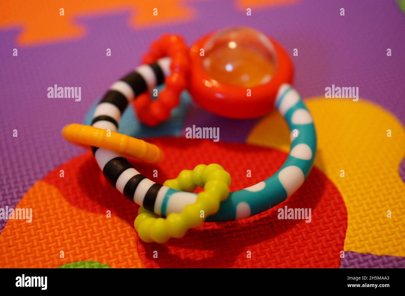 Closeup of a colorful shaking toy on the multi-colored surface Stock ...