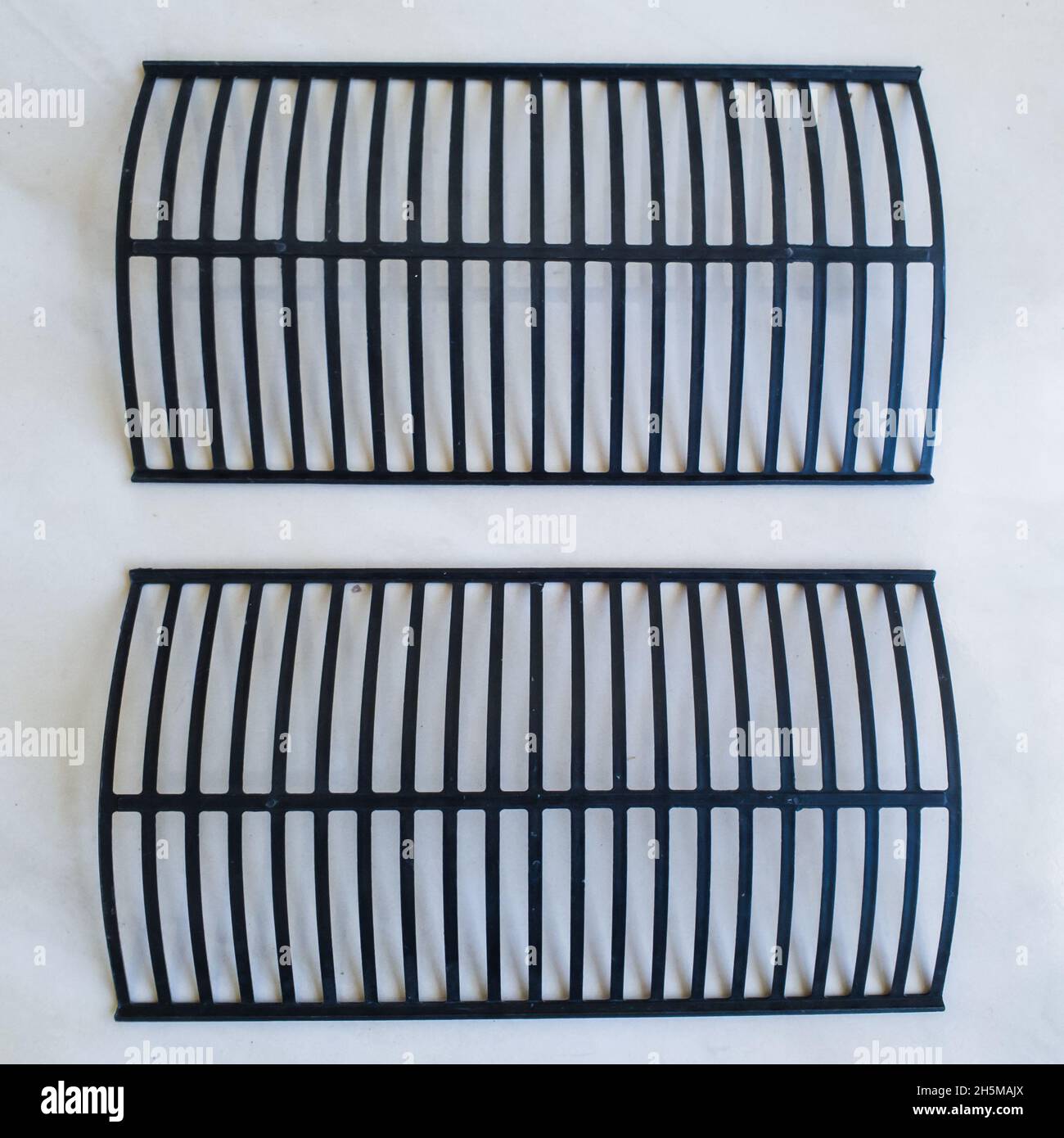 Top view closeup of two black metal plate racks next to each other on a ...