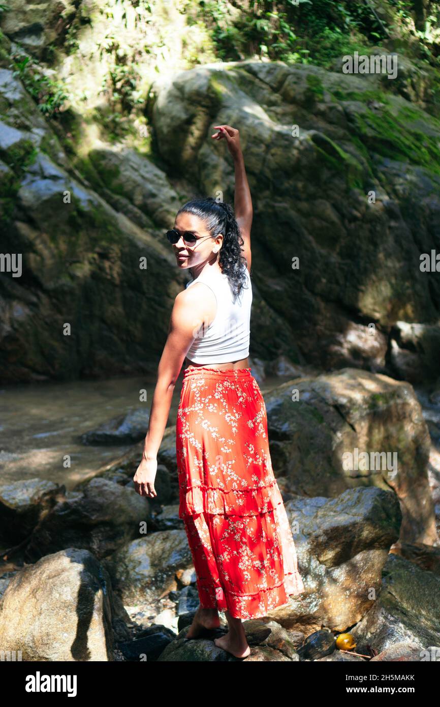 Latin Woman Walks In Nature Near River. Vacation and Tourism Concept ...