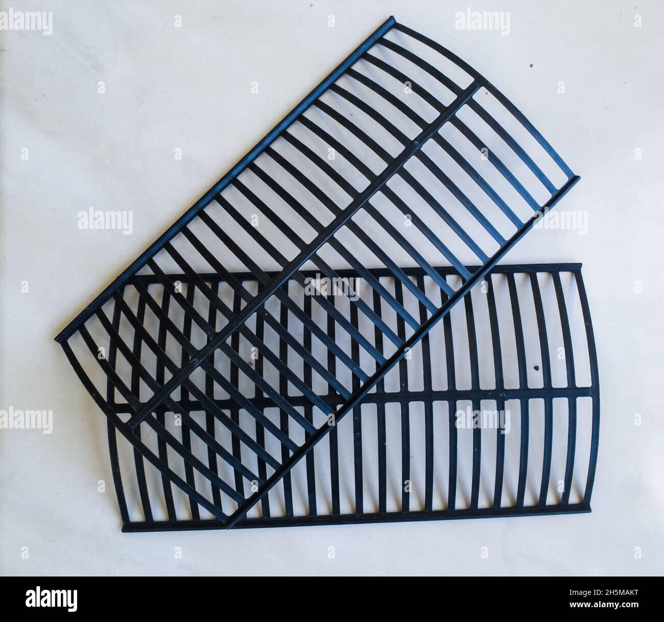 Top view closeup of two black metal plate racks on top of each other on ...
