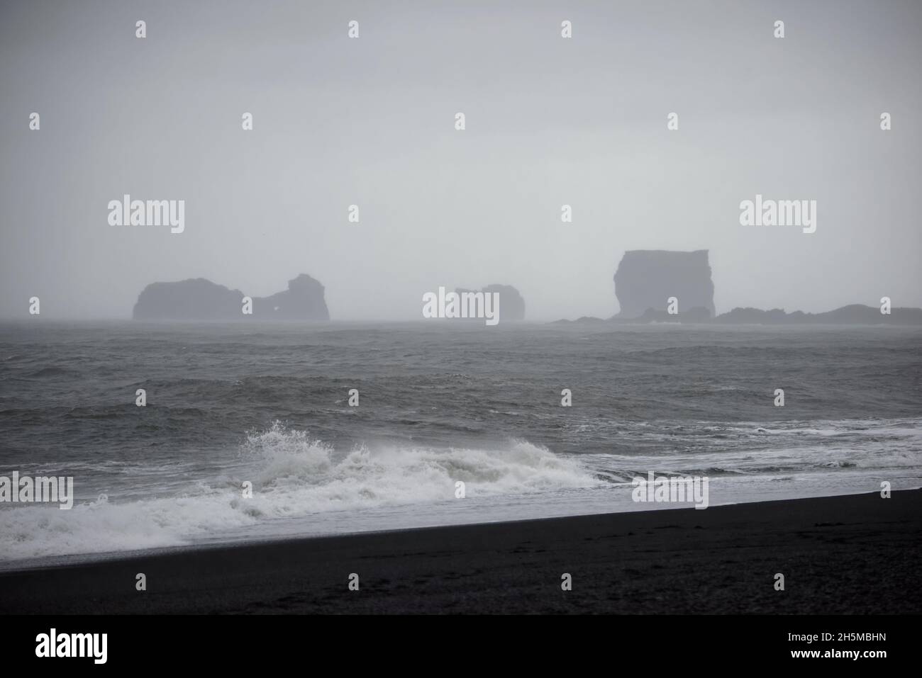 The Reynisdrangar basalt sea stacks and the Reynisfjara black sand ...