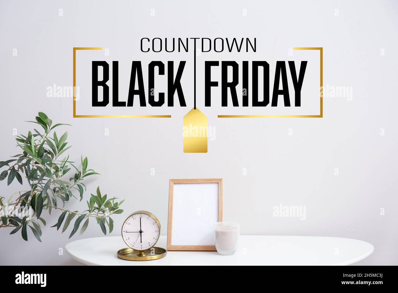Alarm clock on table in room. Black Friday countdown Stock Photo - Alamy