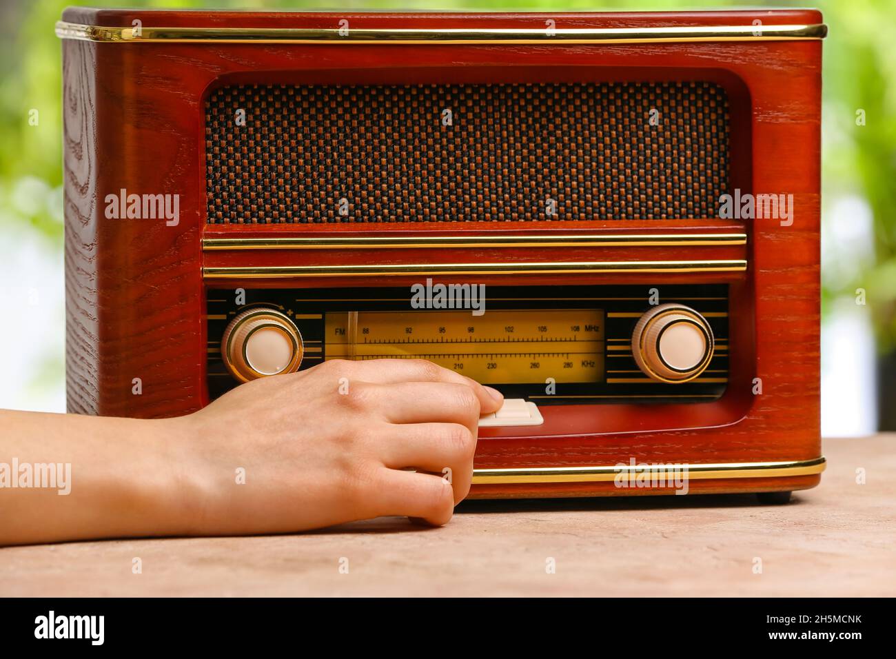 Woman switching on the radio outdoors Stock Photo - Alamy