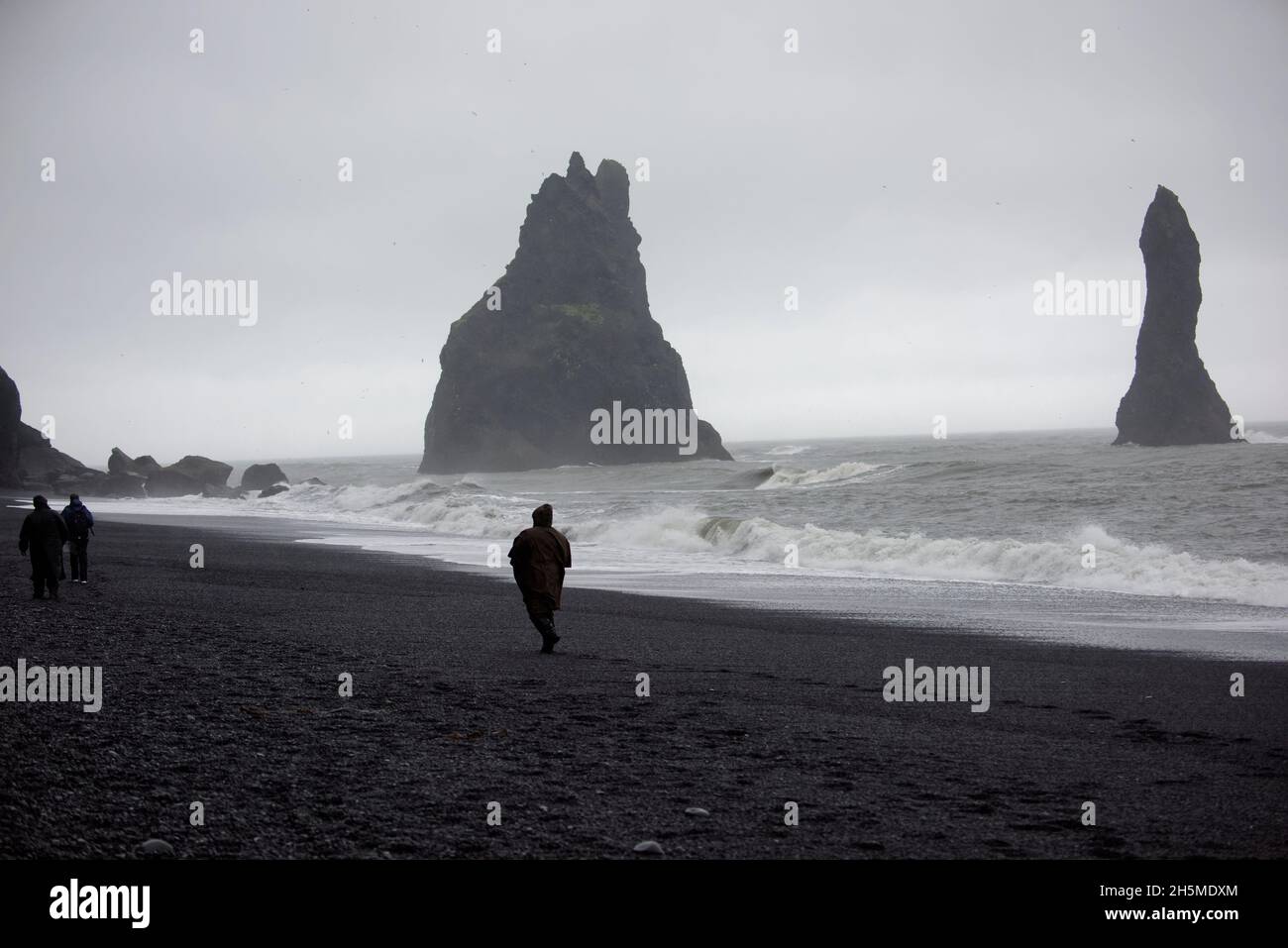 The Reynisdrangar basalt sea stacks and the Reynisfjara black sand ...