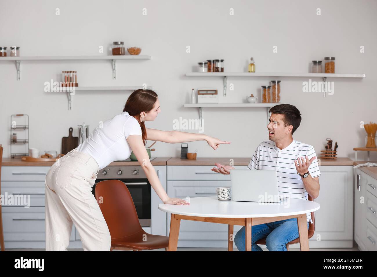 Young couple arguing in kitchen Stock Photo - Alamy