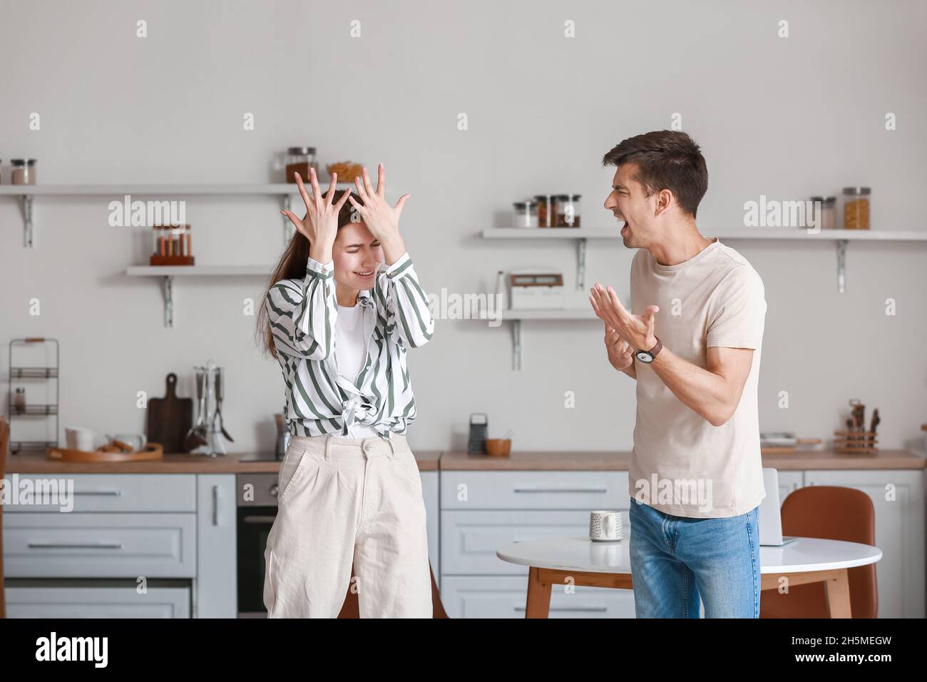 Angry young man shouting at his wife in kitchen Stock Photo - Alamy