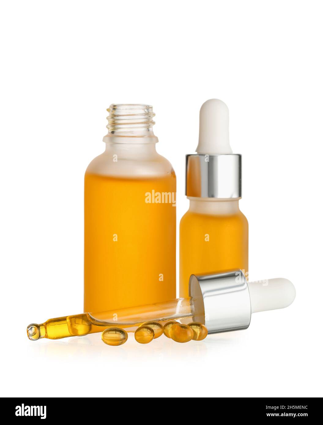 Bottles of essential oil and capsules isolated on white background ...