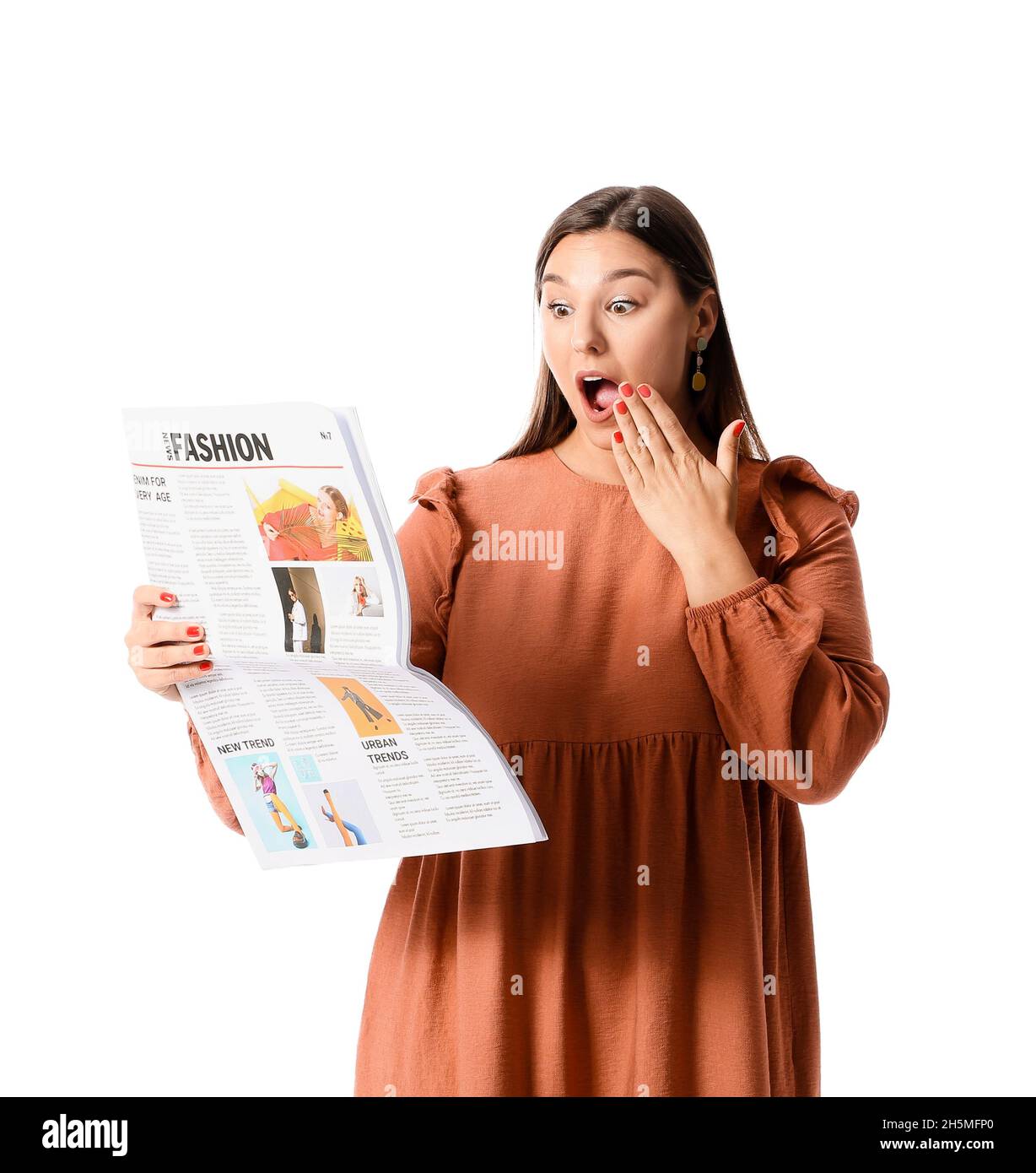 Surprised beautiful woman reading newspaper on white background Stock ...