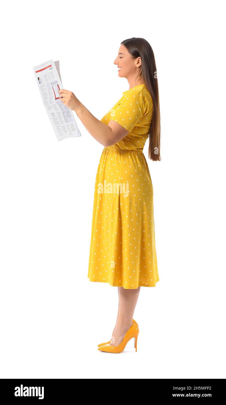 Beautiful woman in yellow dress reading newspaper on white background ...