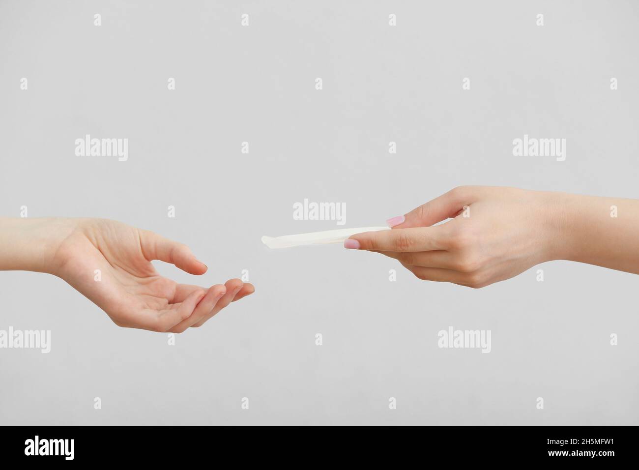 Female hands with menstrual pad on white background Stock Photo - Alamy
