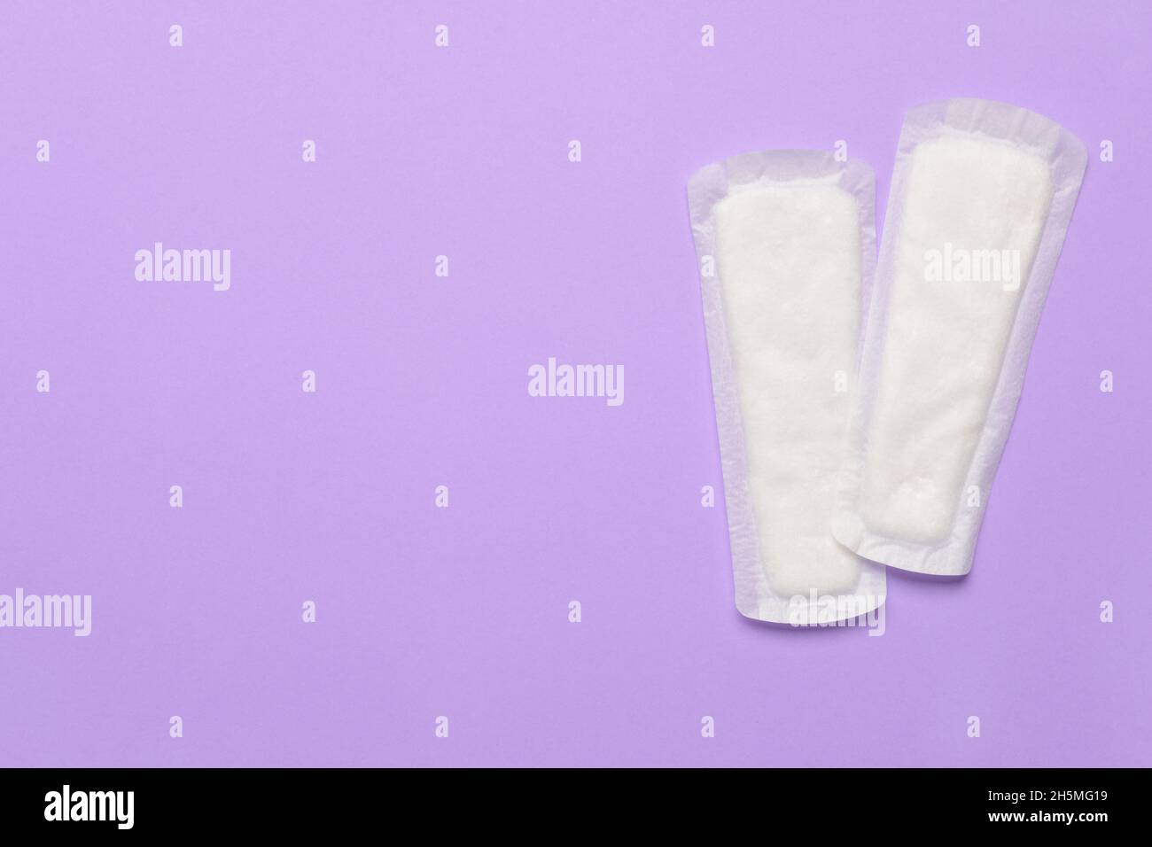 Menstrual pads on purple background Stock Photo - Alamy