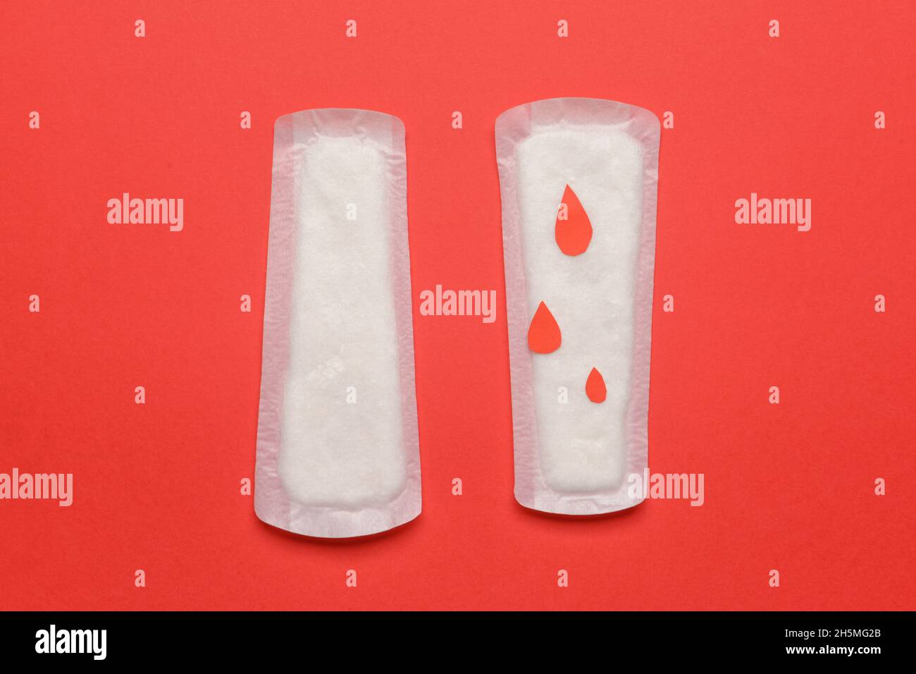Menstrual pads and drawn blood drops on red background Stock Photo - Alamy