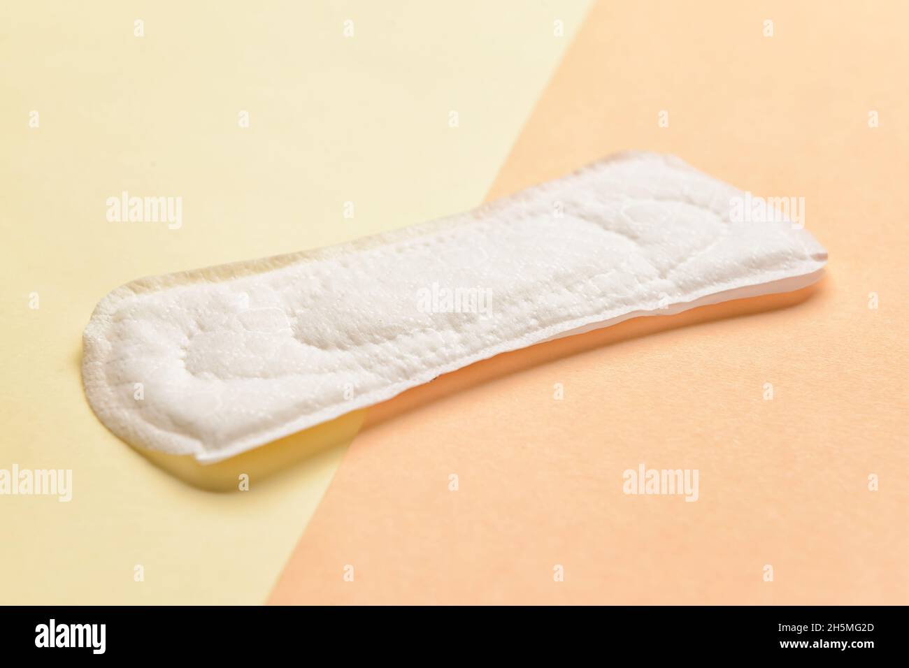 Menstrual pad on yellow background Stock Photo - Alamy