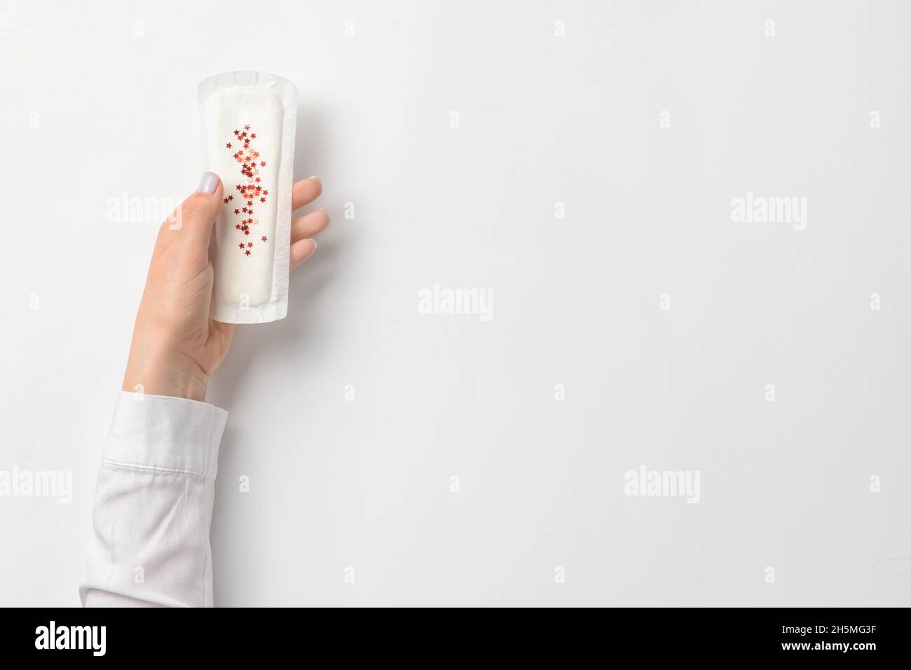 Female hand with menstrual pad on white background Stock Photo - Alamy