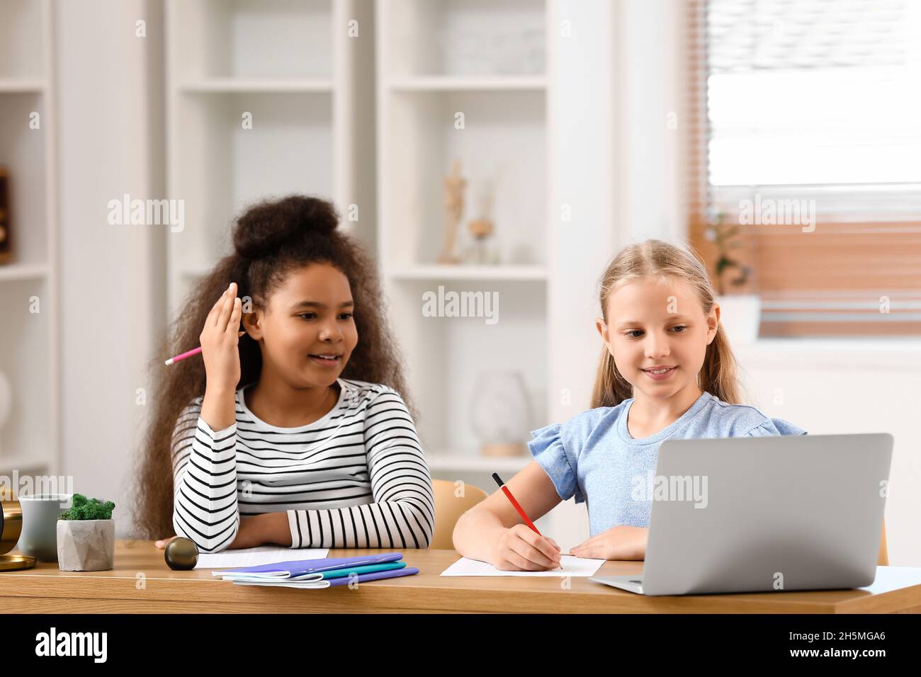 Little pupils studying online at home Stock Photo - Alamy