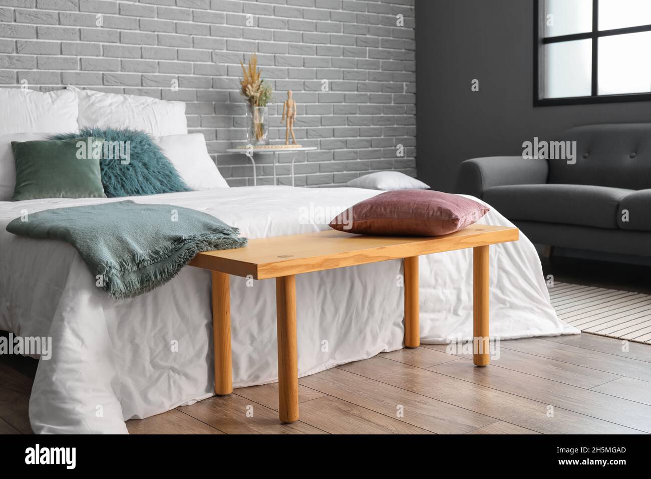 Wooden bench with pillow in interior of modern bedroom Stock Photo - Alamy